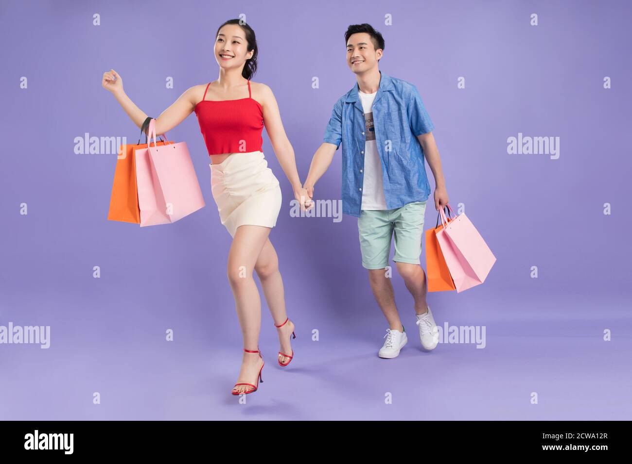 Hand in hand shopping young partner Stock Photo - Alamy