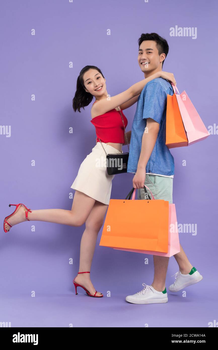 Carrying shopping bags of happy young partner Stock Photo - Alamy