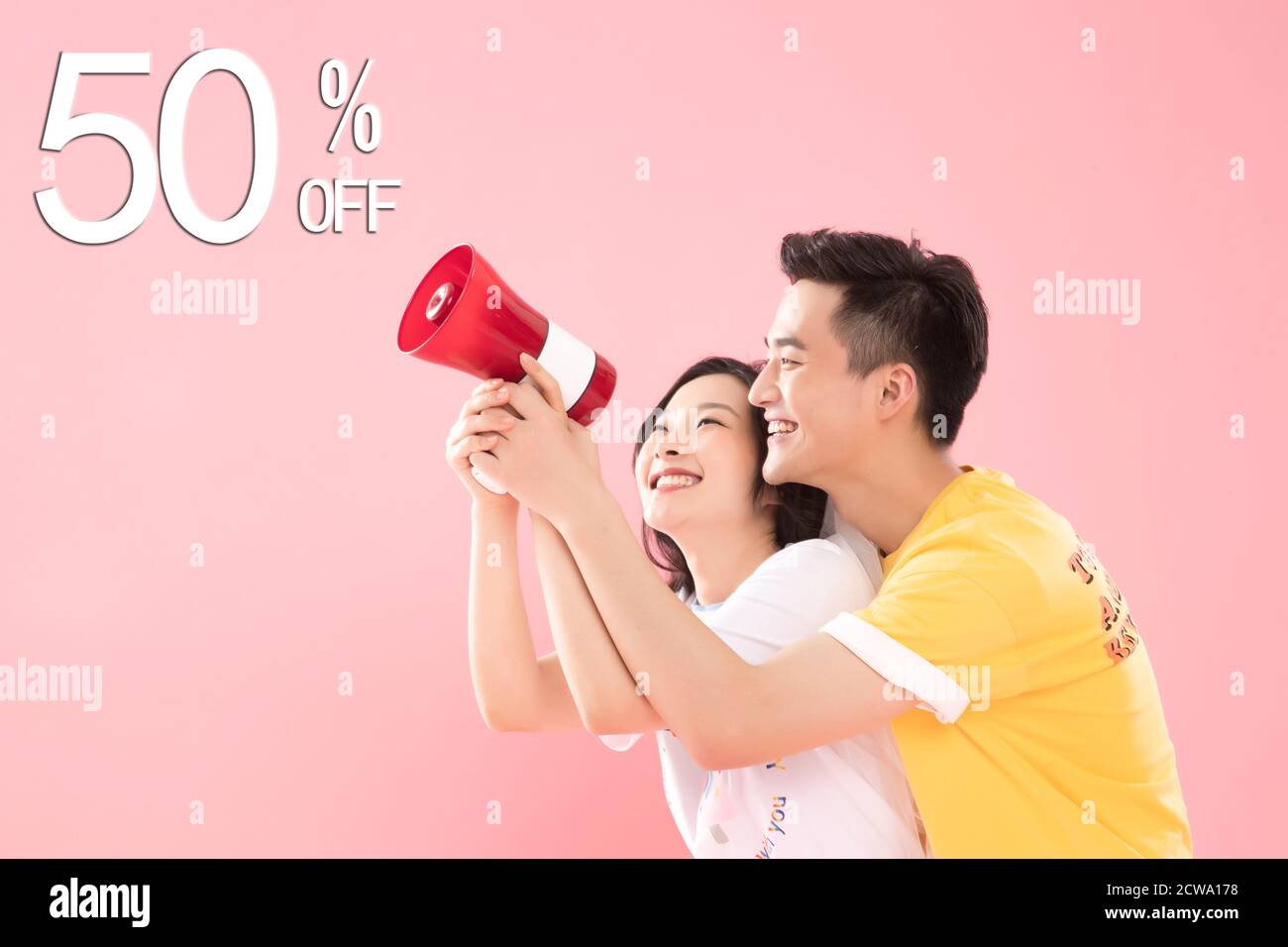Fashionable young couples holding megaphone Stock Photo - Alamy