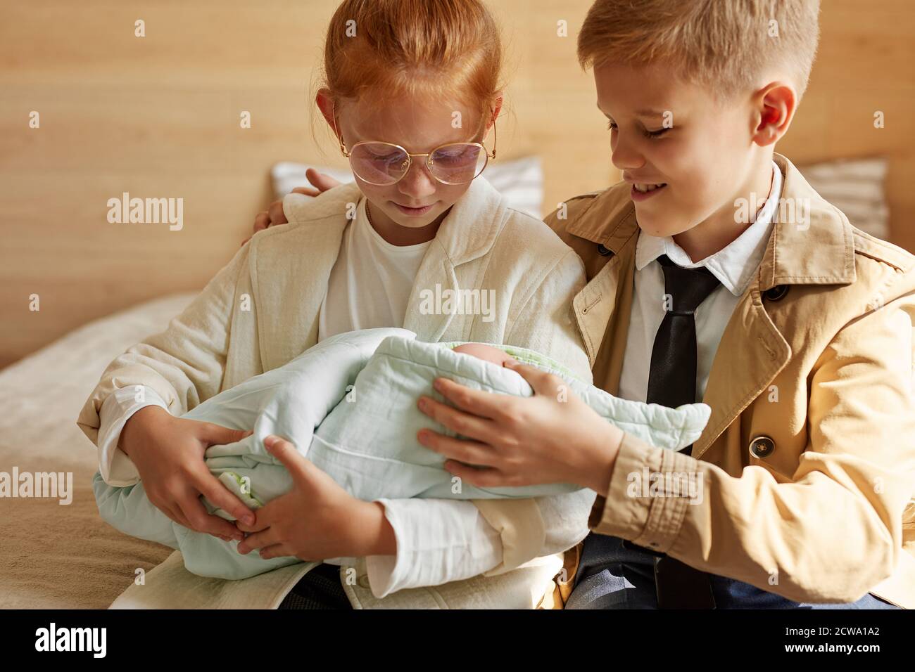 young parents, children take care of baby, kids make family, love their ...