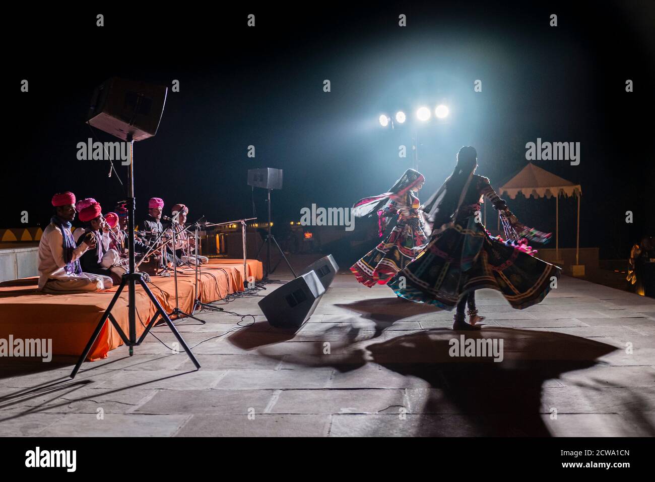 Traditional Rajasthani folk dancers and musicians performing at night ...