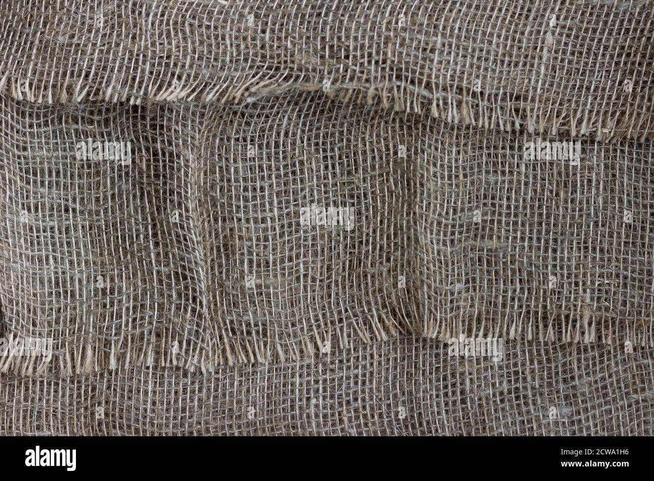 The structure of the threads of a natural burlap fabric close up Stock ...