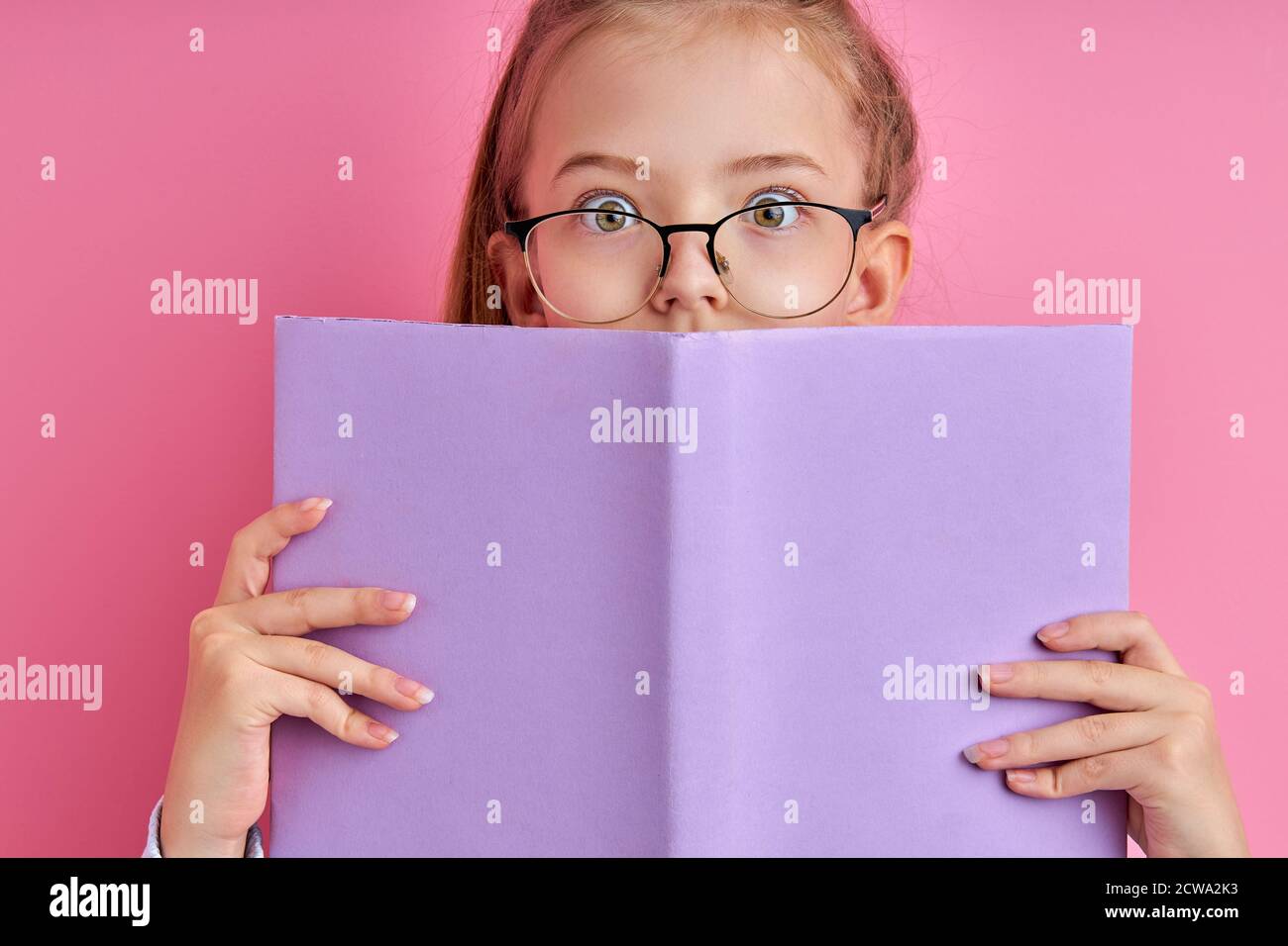 beautiful little girl stay in shock after reading a book, she is ...