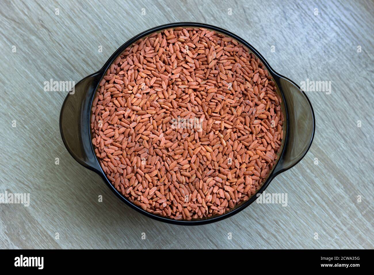 Uzbek rice devzira for cooking pilaf in a round cup on the table Stock ...