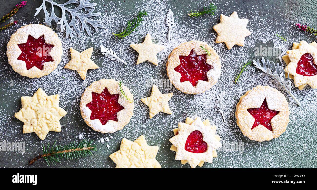 Traditional Linzer Christmas cookies with raspberry jam on green ...