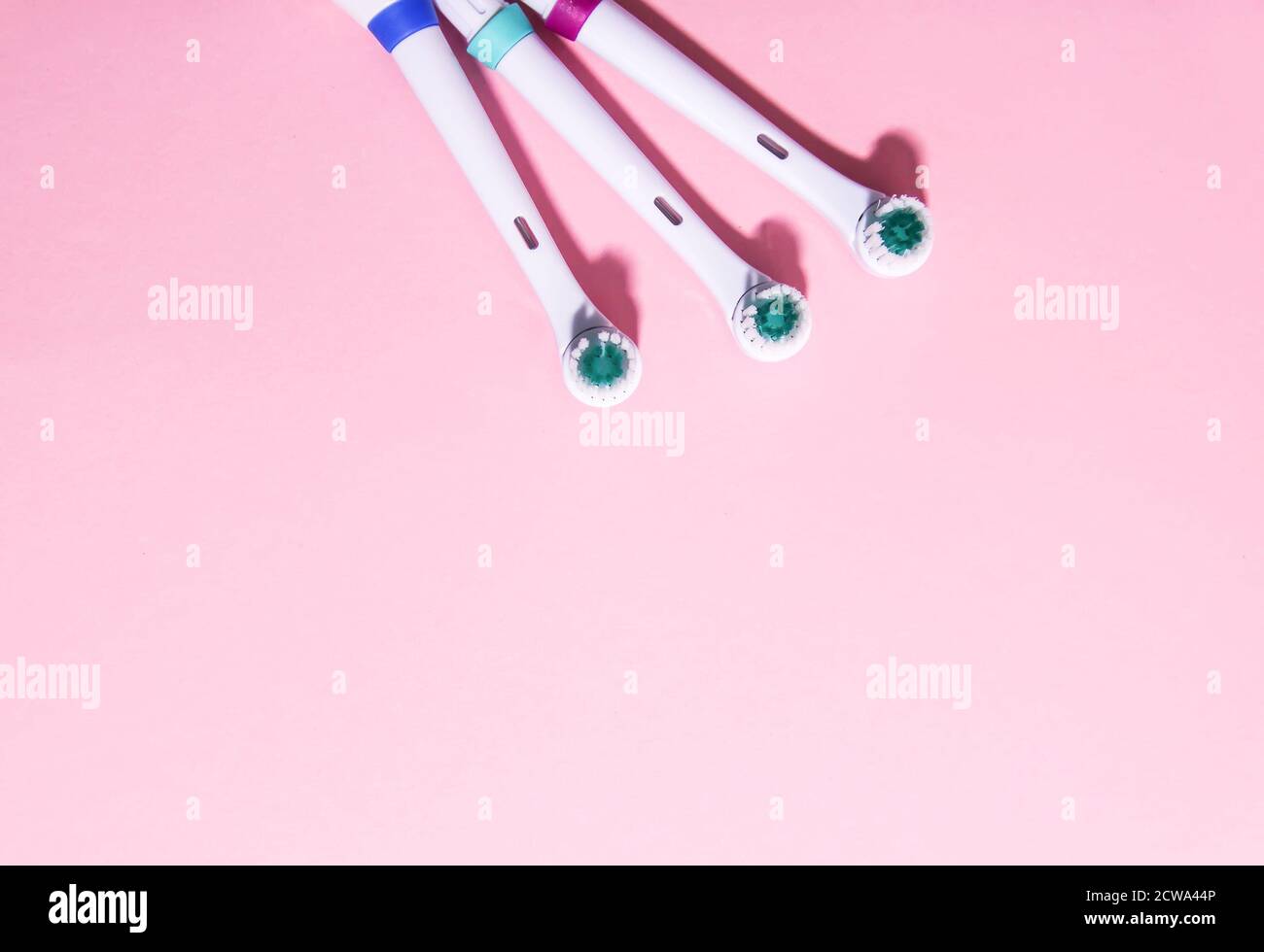 Two electrical toothbrushes on a soft light pink background Stock Photo ...