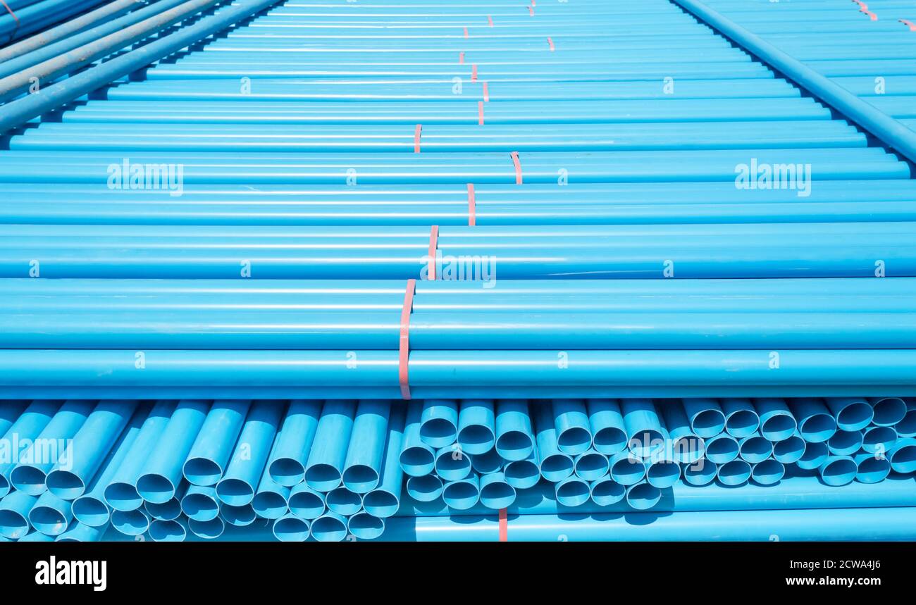 PVC pipes stacked in warehouse Stock Photo - Alamy