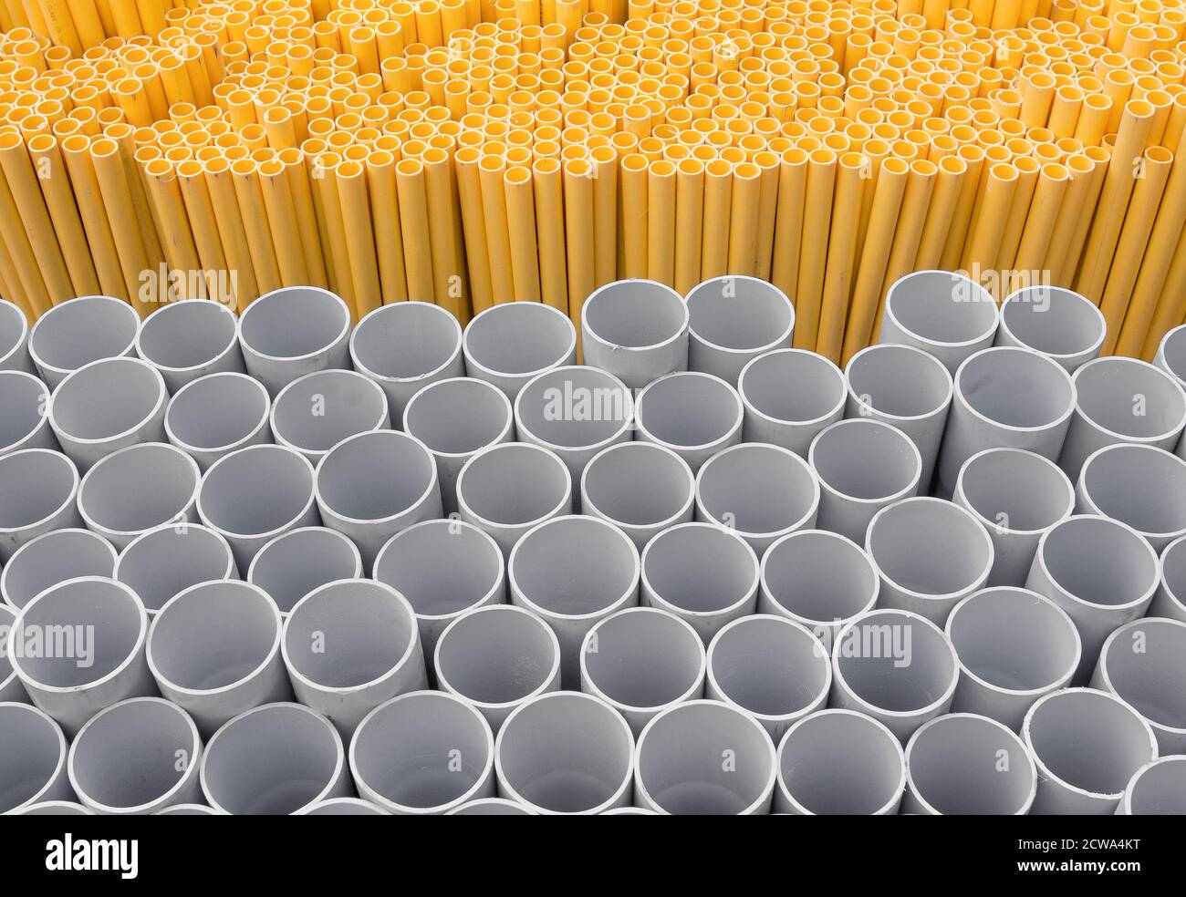 PVC pipes stacked in warehouse Stock Photo - Alamy