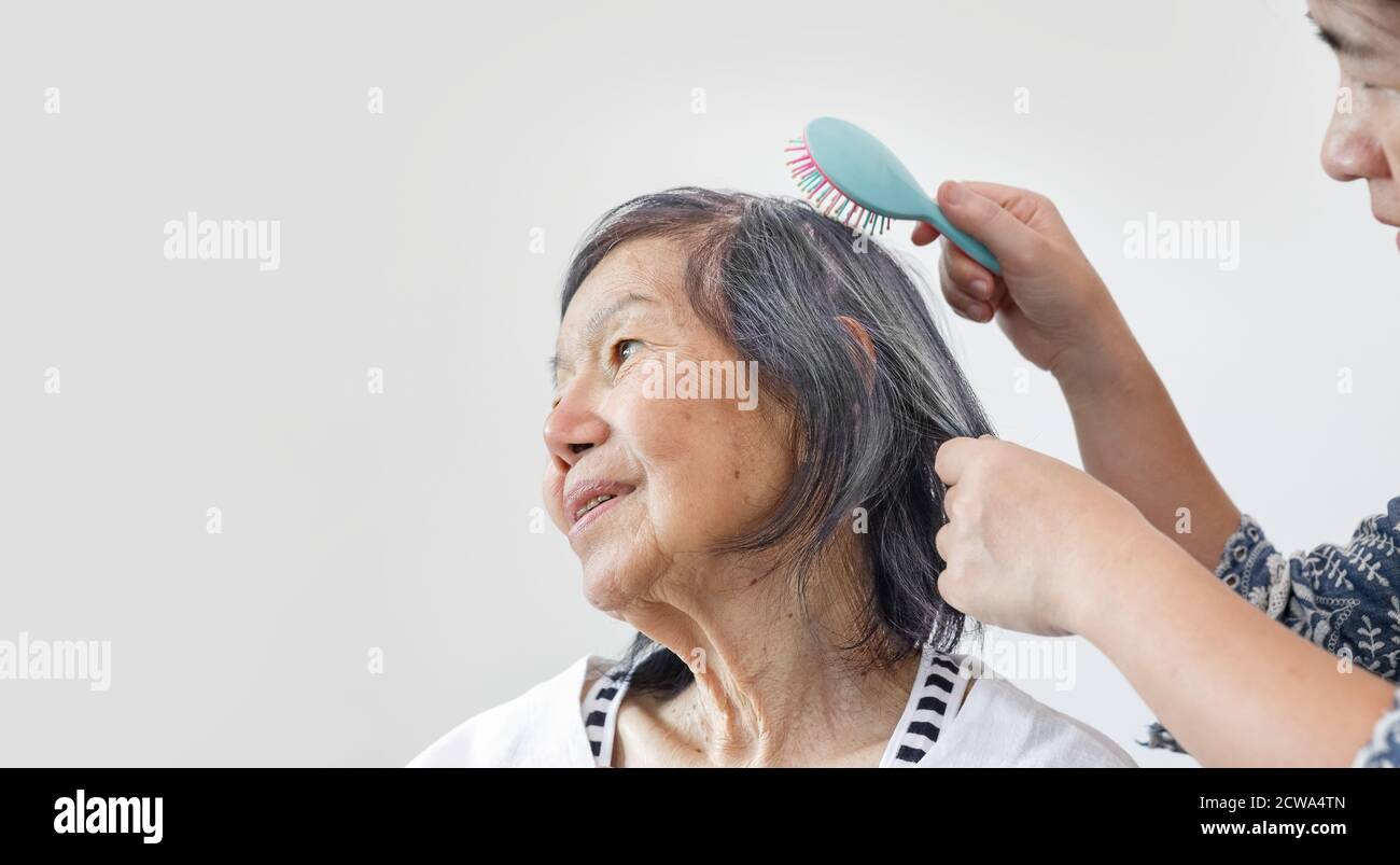 Woman combing hair of elderly mother hi-res stock photography and ...