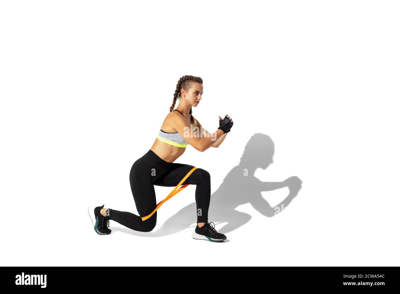 Sit ups. Beautiful young female athlete practicing on white studio ...