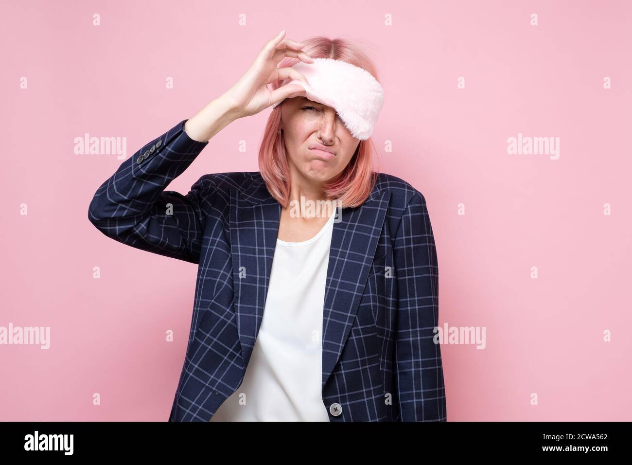 Caucasian woman peeping from a sleeping mask, feeling tired Stock Photo ...