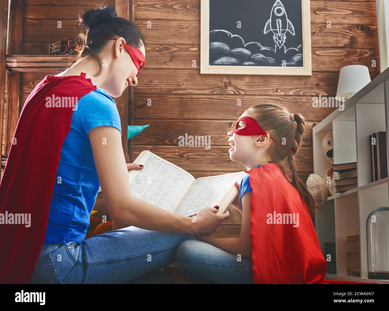 Superhero reading book hi-res stock photography and images - Alamy
