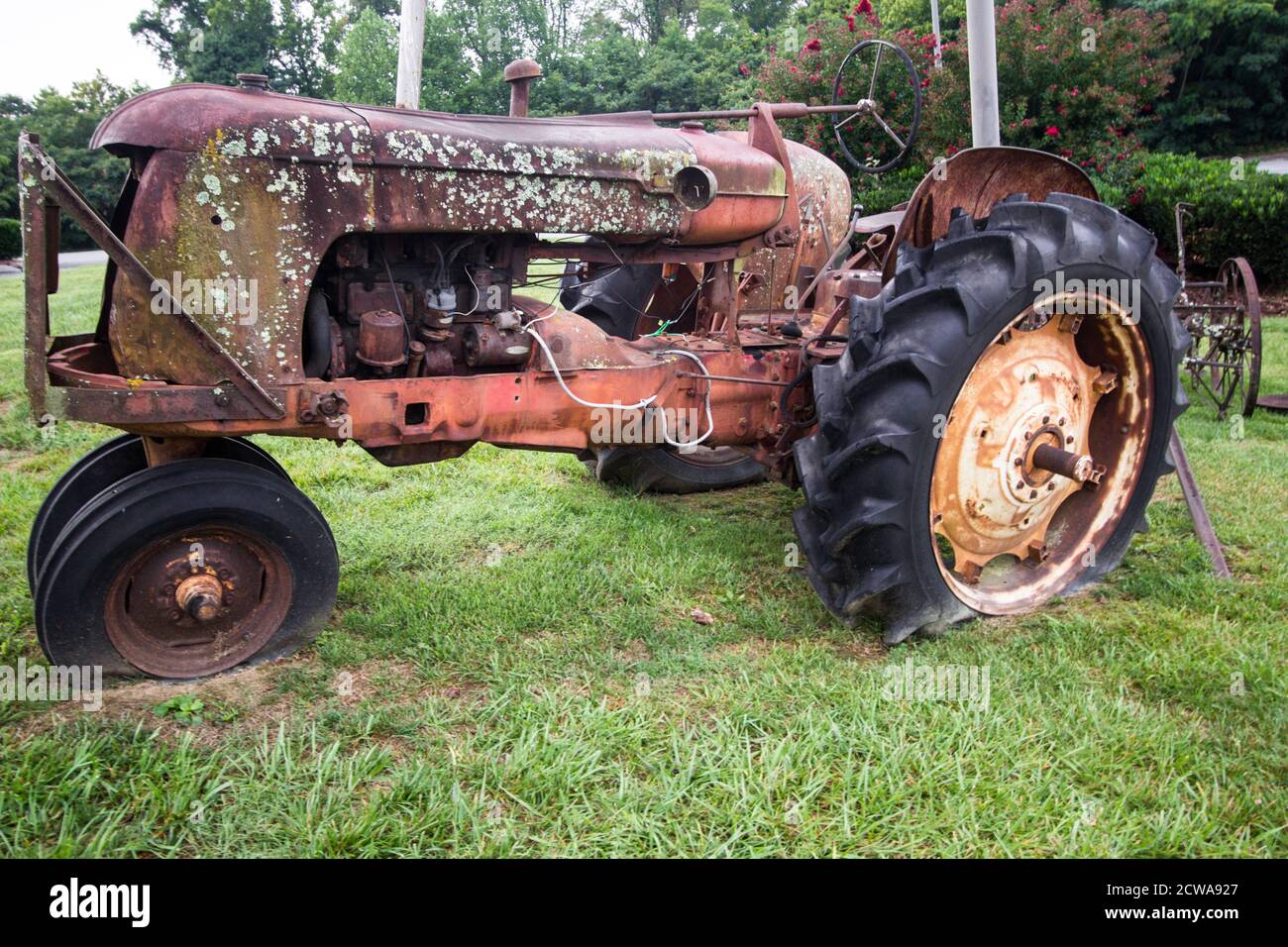 Old Rusty Tractor with flat tires Stock Photo - Alamy