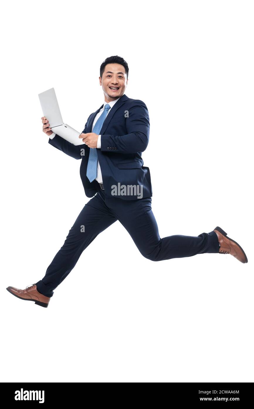 Carrying a laptop business men jump Stock Photo - Alamy