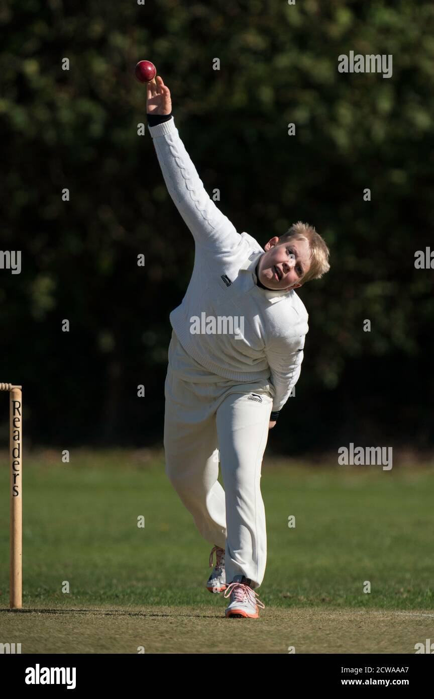Junior spin bowler in action Stock Photo - Alamy