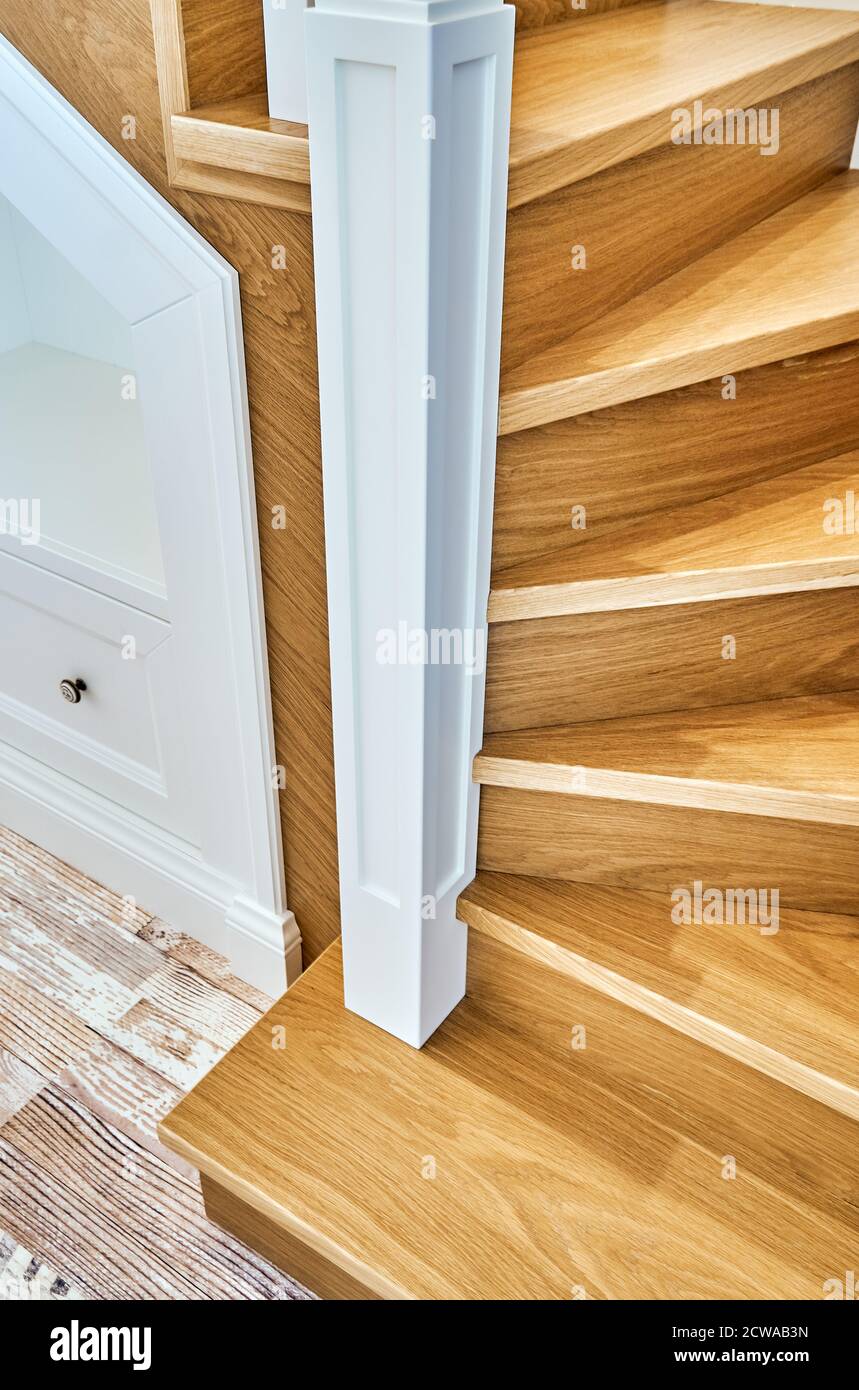 Winder steps of a wooden staircase with built-in wardrobe. View from ...