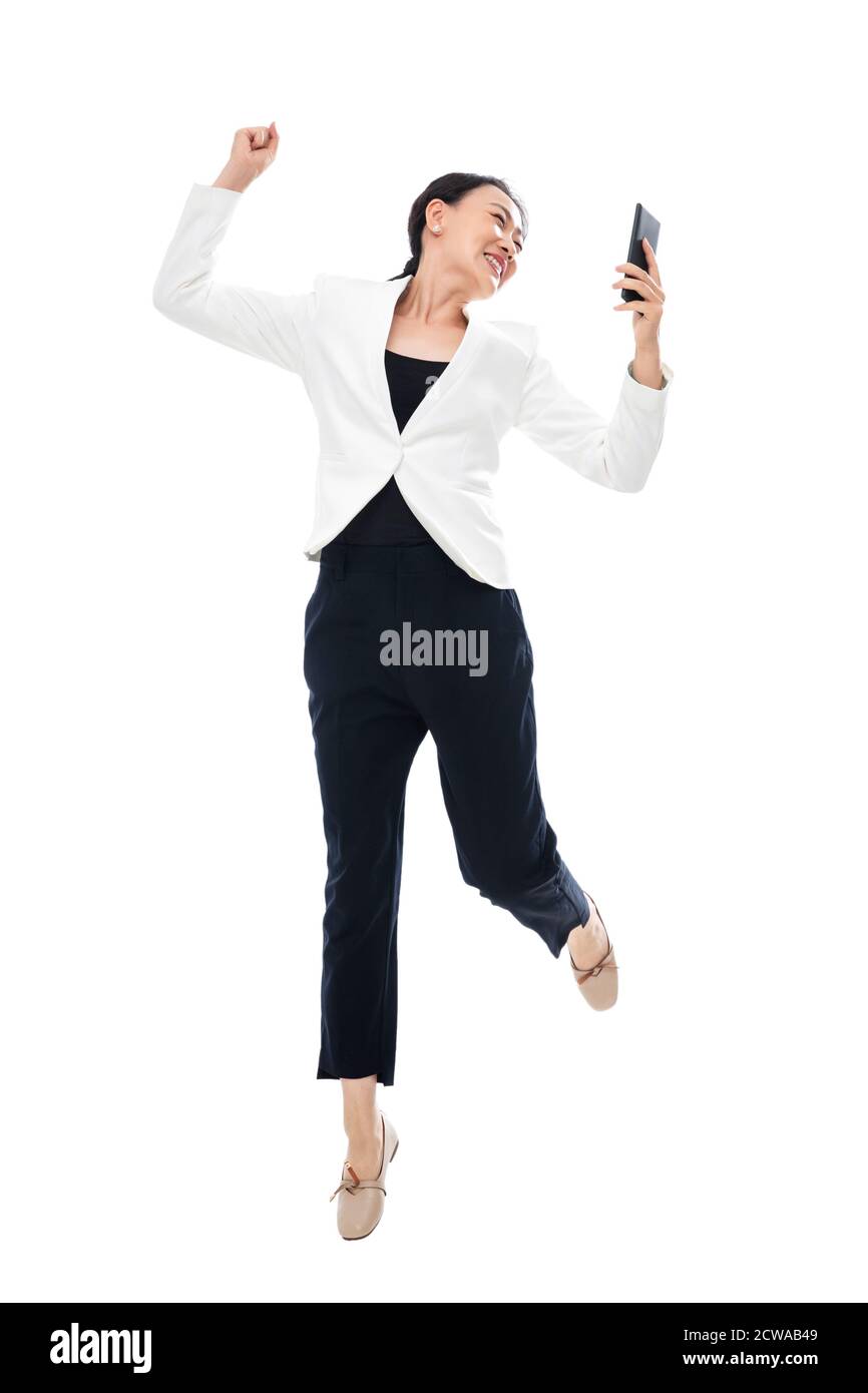 Holding a mobile phone exciting business lady Stock Photo - Alamy