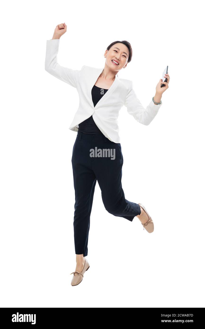 Holding a mobile phone exciting business lady Stock Photo - Alamy