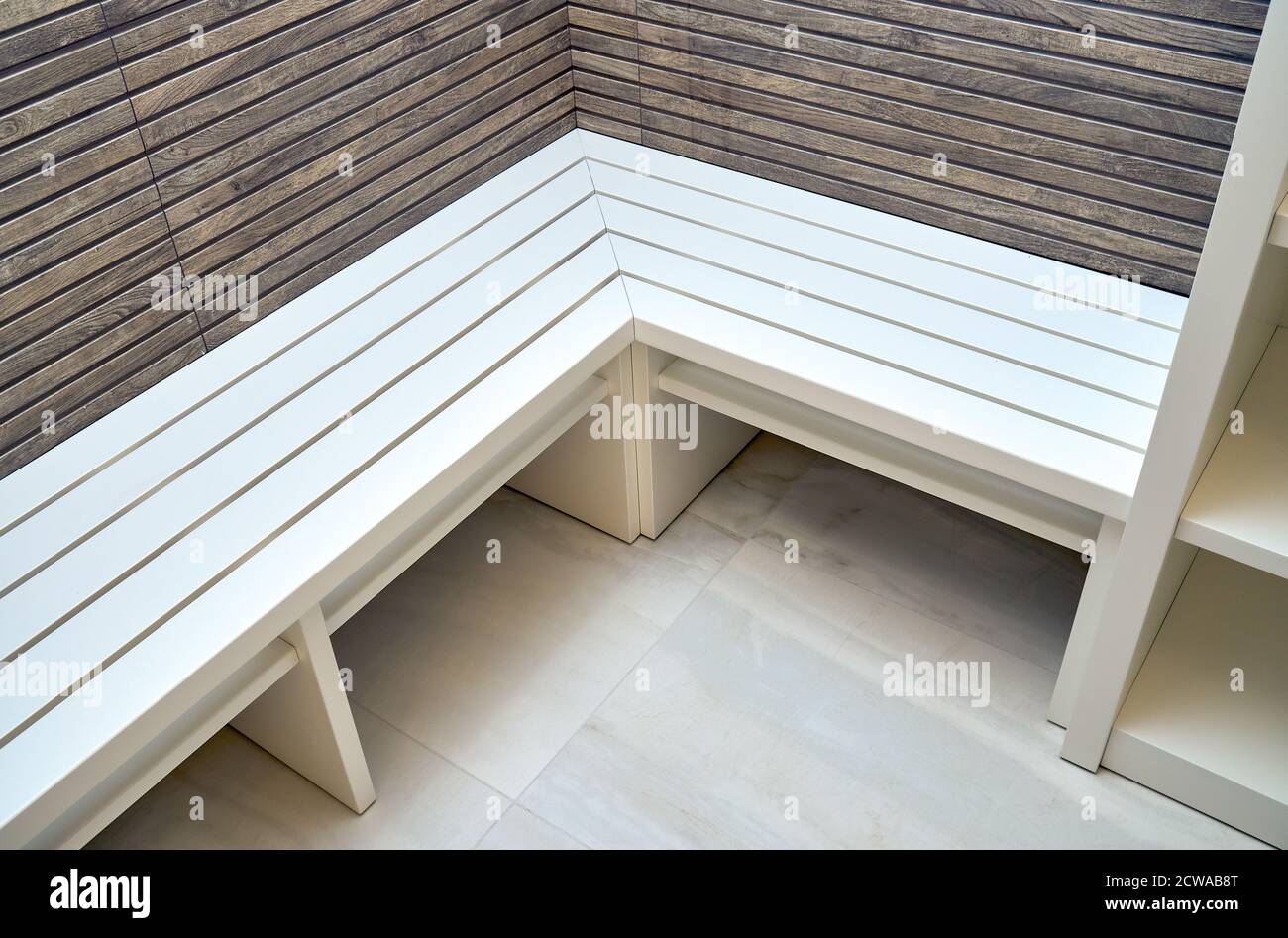 Wardrobe bench with shelves on wooden slats wall background Stock Photo ...