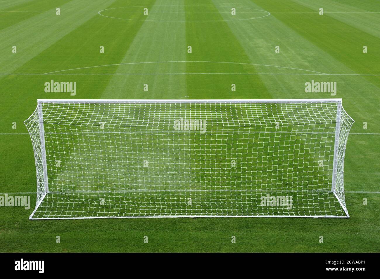 Football goals from behind looking across the pitch Stock Photo - Alamy
