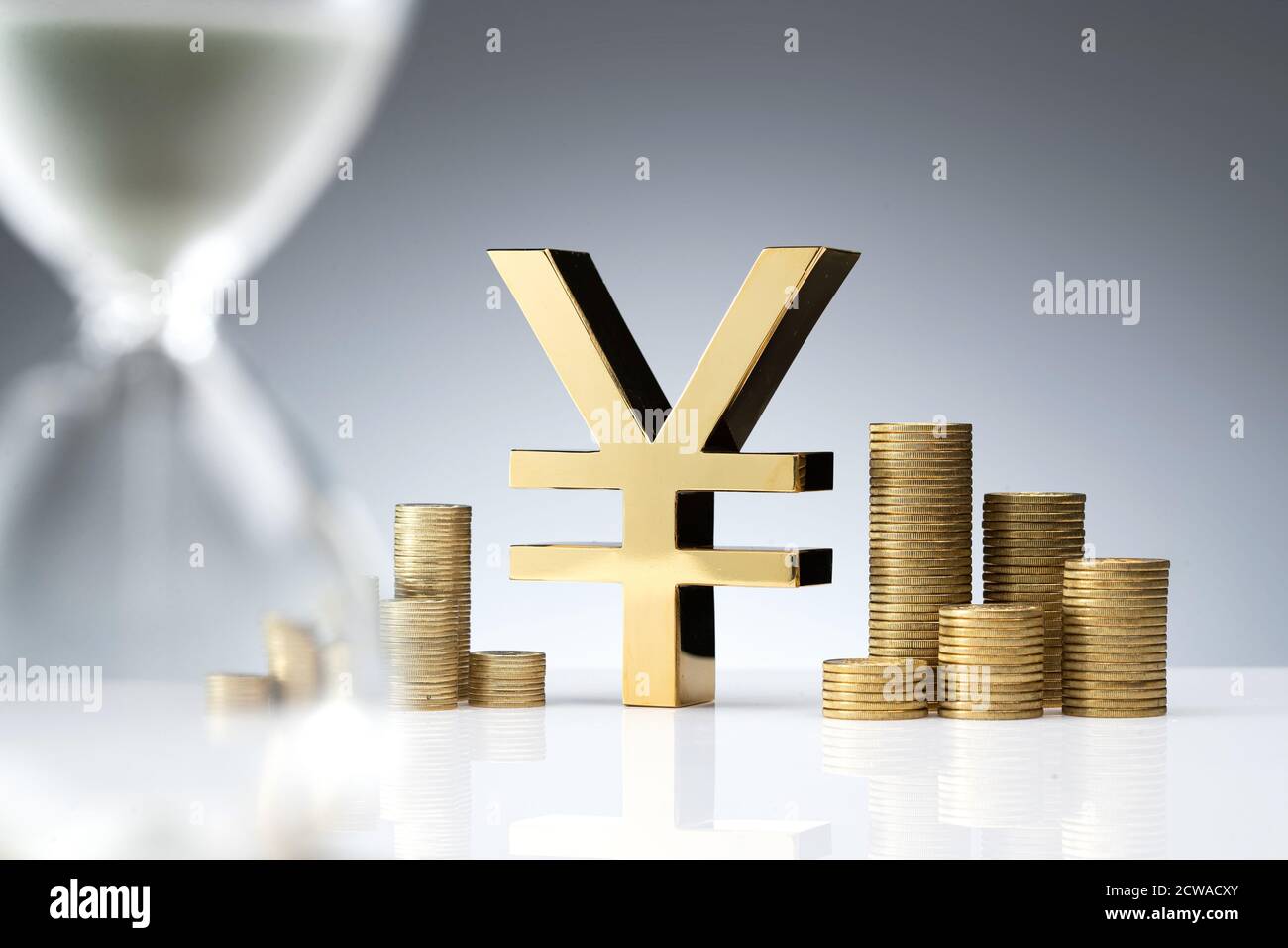Gold currency symbol and an hourglass Stock Photo - Alamy