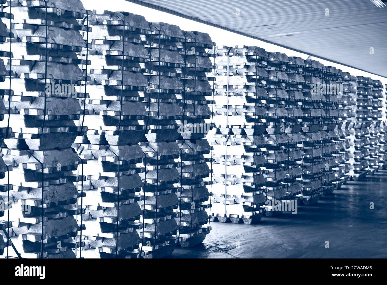 Aluminum ingot bar stacked in warehouse. Raw material for industrial ...