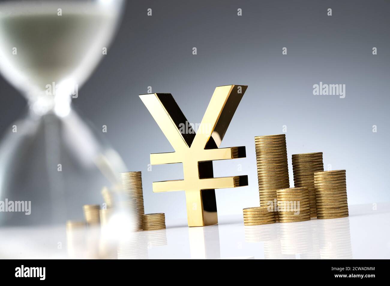 Gold currency symbol and an hourglass Stock Photo - Alamy