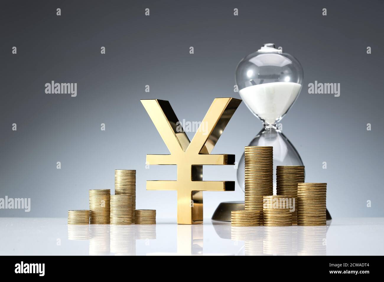 Gold currency symbol and an hourglass Stock Photo - Alamy