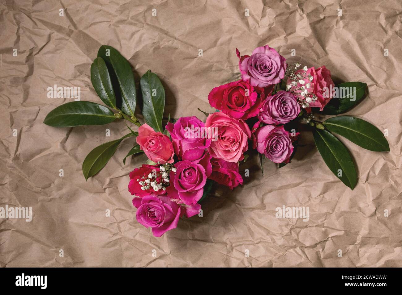 Creative layout with beautiful pink roses flowers and green leaves on ...