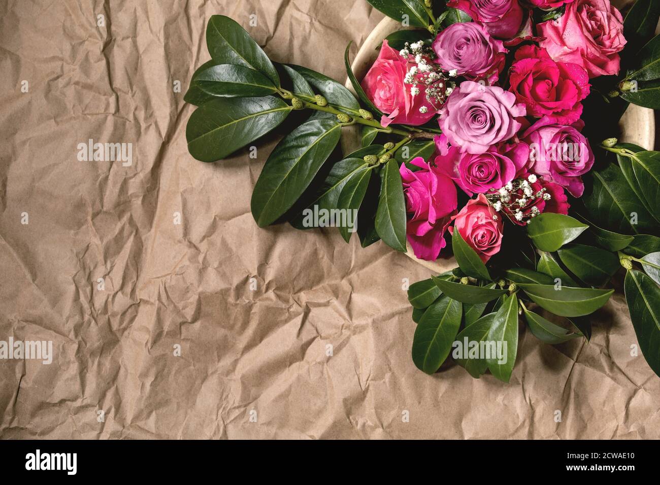 Creative layout with beautiful pink roses flowers and green leaves on ...