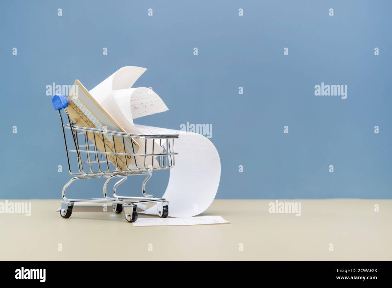 A mini shopping cart full of bank CARDS and bills Stock Photo - Alamy