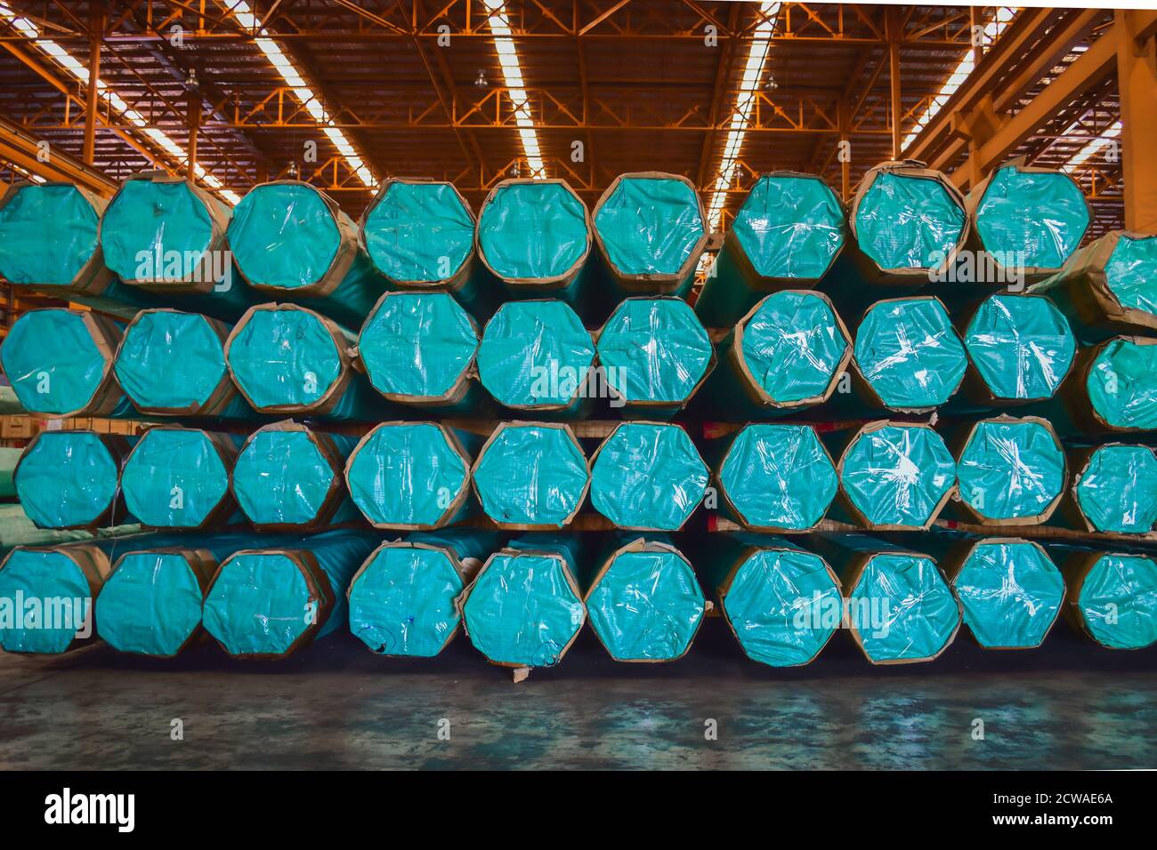 Pack of steel round bar stack in layer inside large distribution ...