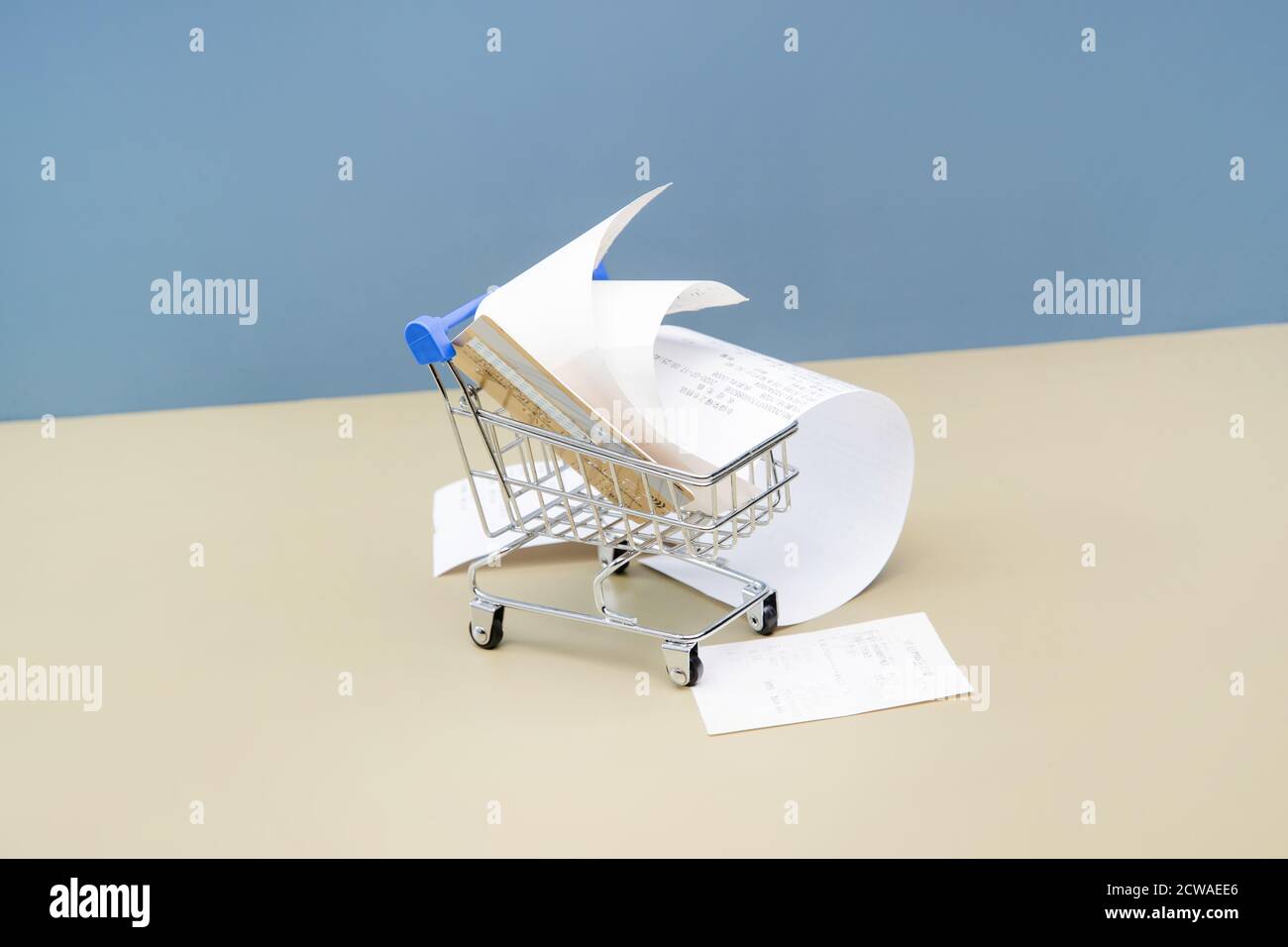 A mini shopping cart full of bank CARDS and bills Stock Photo - Alamy