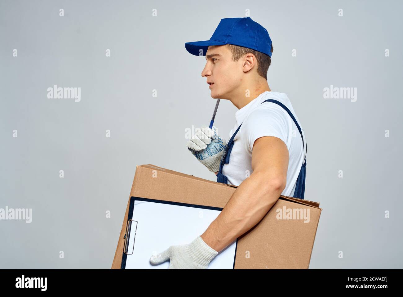 Man worker with box in hands delivery loading service packing service ...