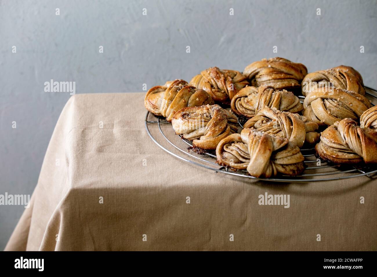 Traditional Swedish cardamom sweet buns Kanelbulle on cooling rack on ...