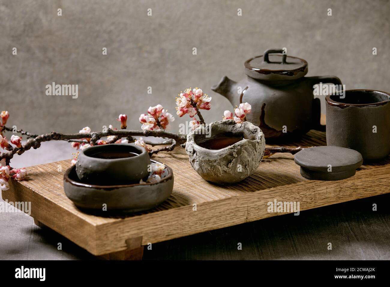 Tea drinking wabi sabi japanese style dark clay cups and teapot on ...