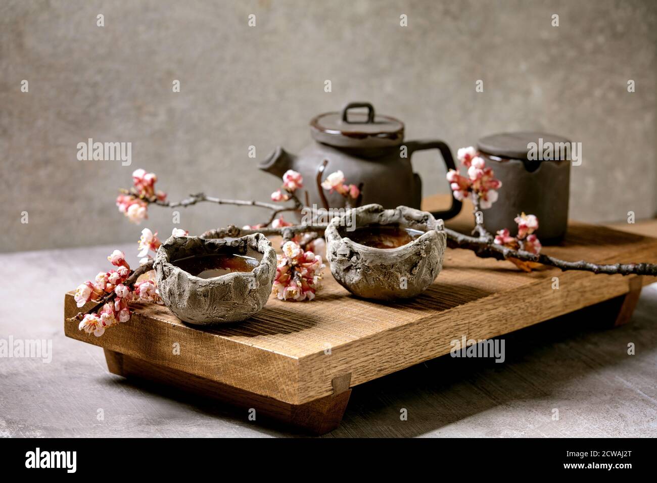 Tea drinking wabi sabi japanese style dark clay cups and teapot on ...