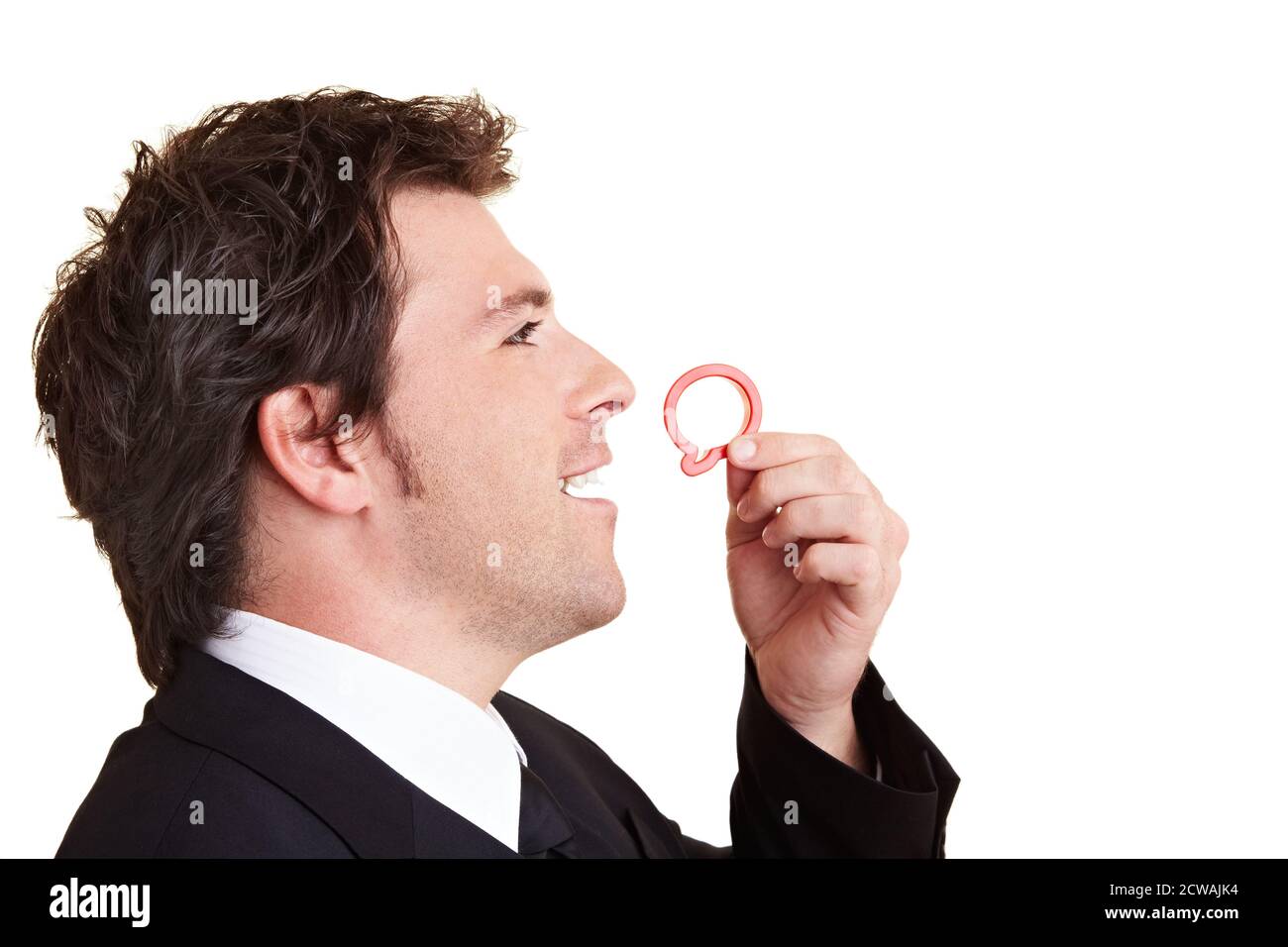 Manager holds a red speech bubble in front of his open mouth Stock ...