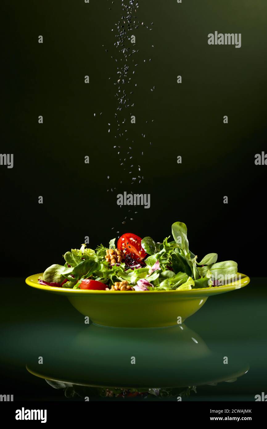 Green salad with cherry tomatoes, walnuts and vegetable oil sprinkle ...