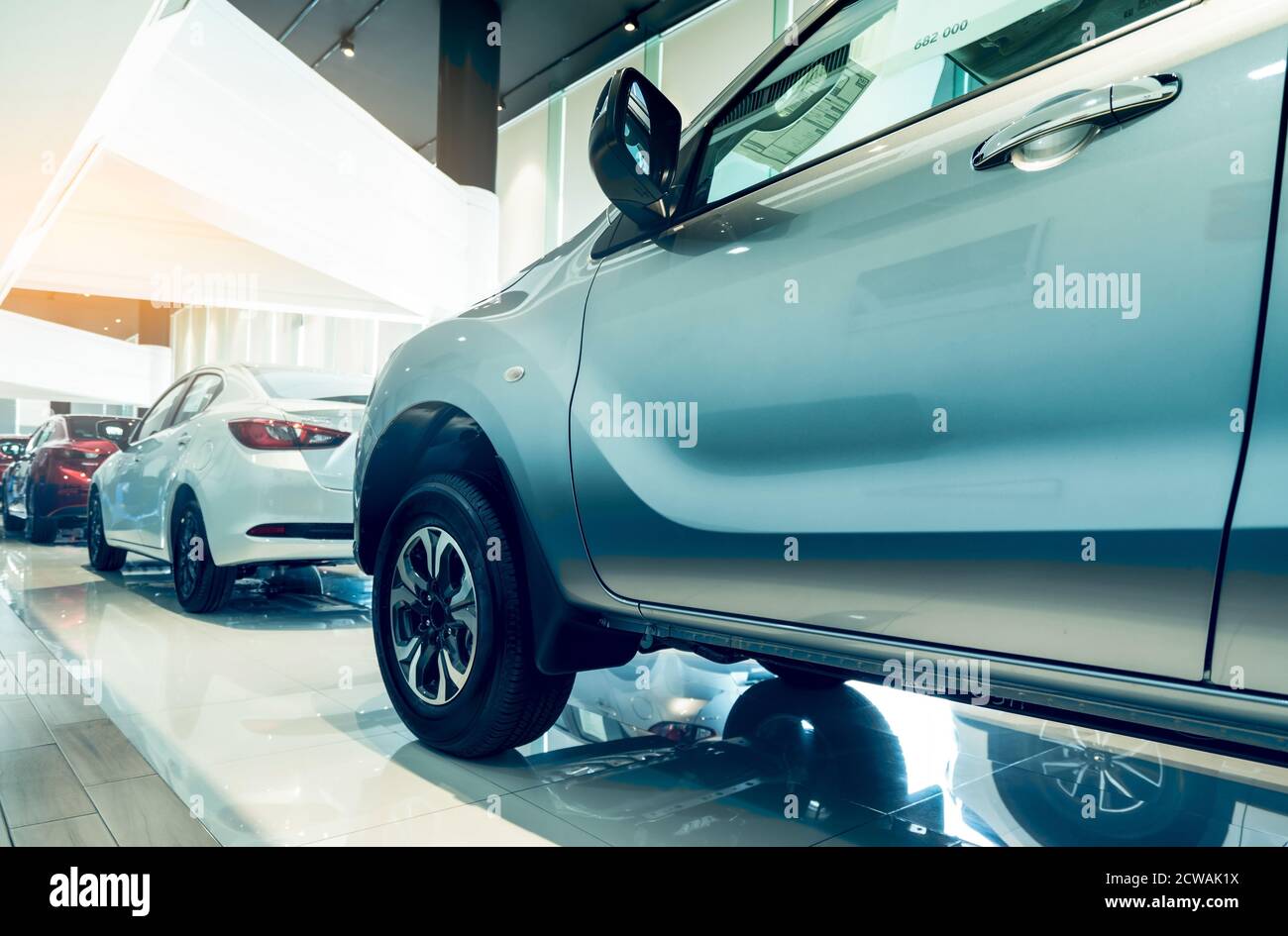 New car parked in modern showroom. Auto leasing and car dealership ...