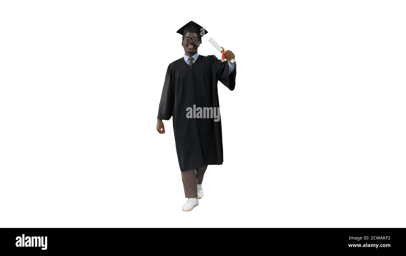 Happy african american male student in graduation robe walking w Stock ...