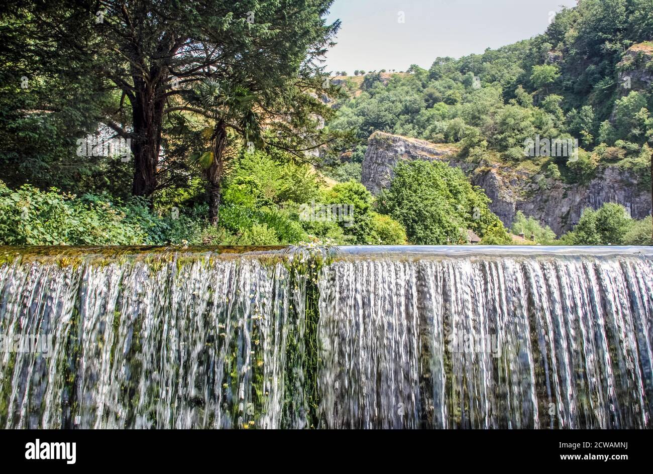 The waterfall of the Cheddar Yeo at Cheddar Gorge, Somerset, with the ...