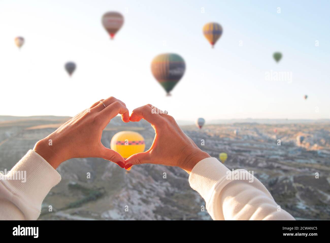 Flying balloons in the sky and female hands reaching for them Stock ...