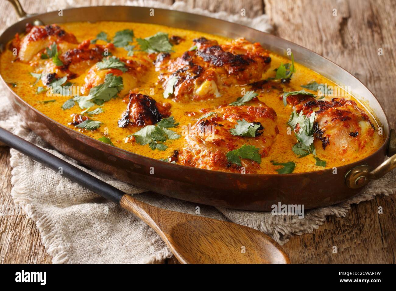 Kenyan Kuku Paka is a chicken roasted over charcoal and then cooked in ...