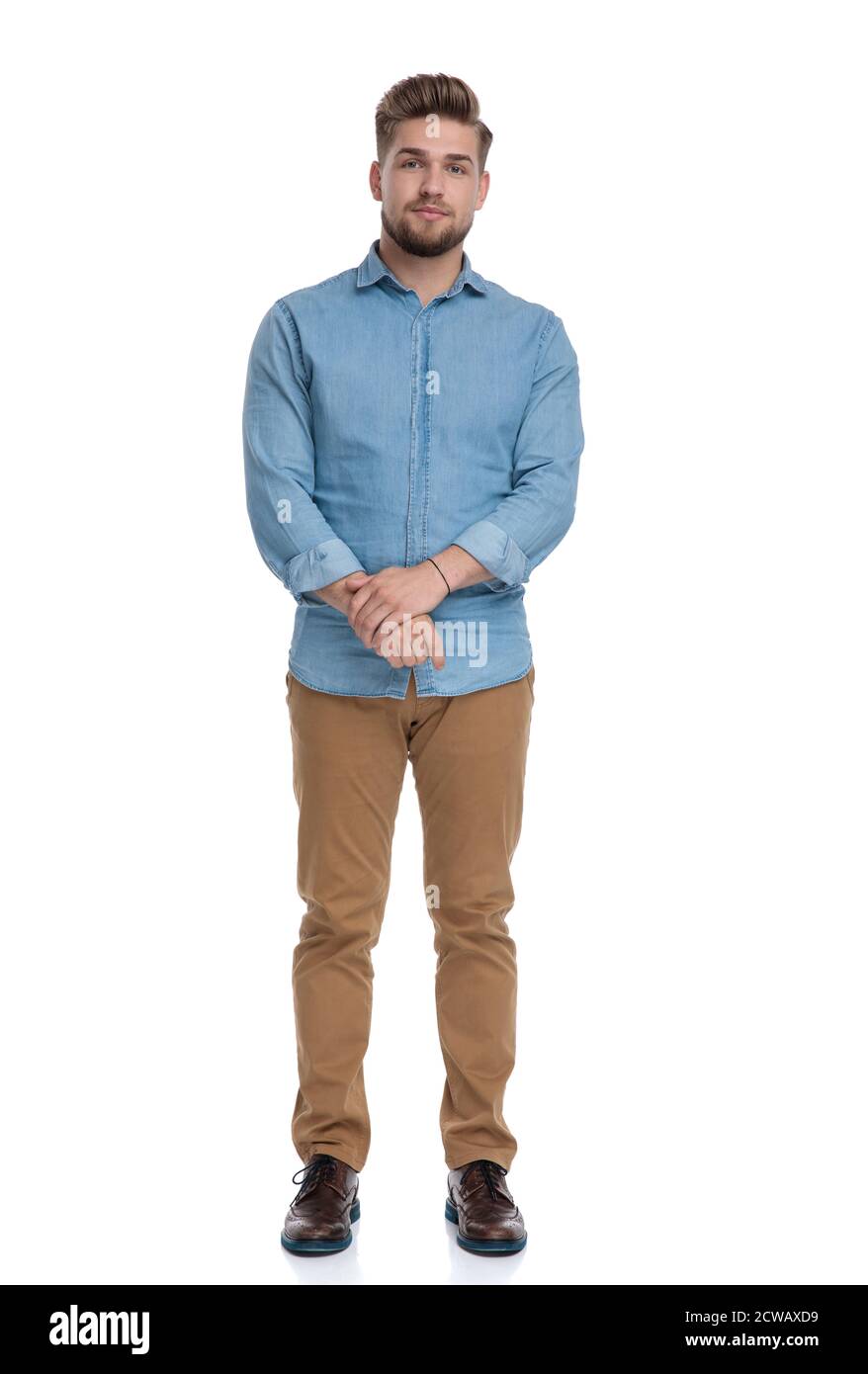 Focused casual man looking forward and listening while standing on ...