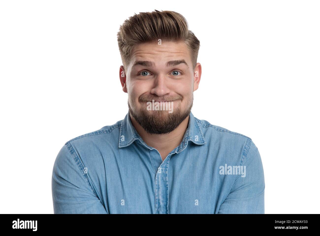 Casual man making a funny face while having a difficulty while wearing ...