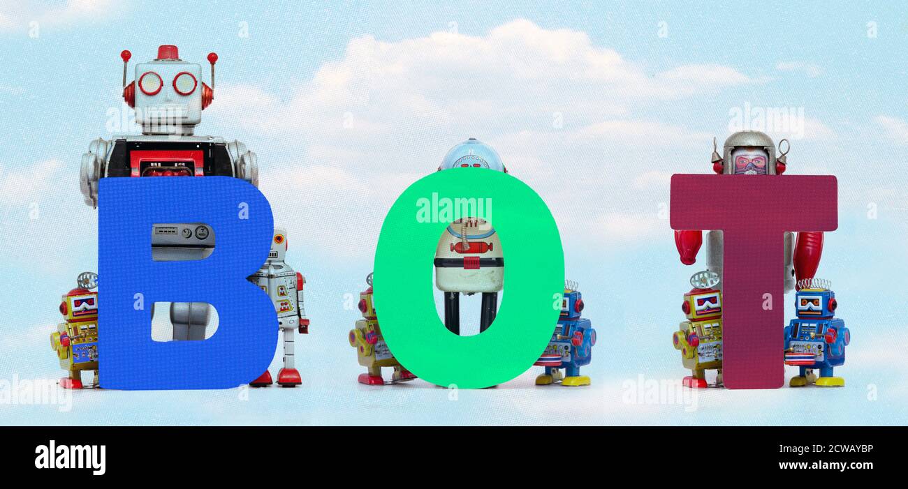 vintage toy robots holding up the word BOT Stock Photo - Alamy