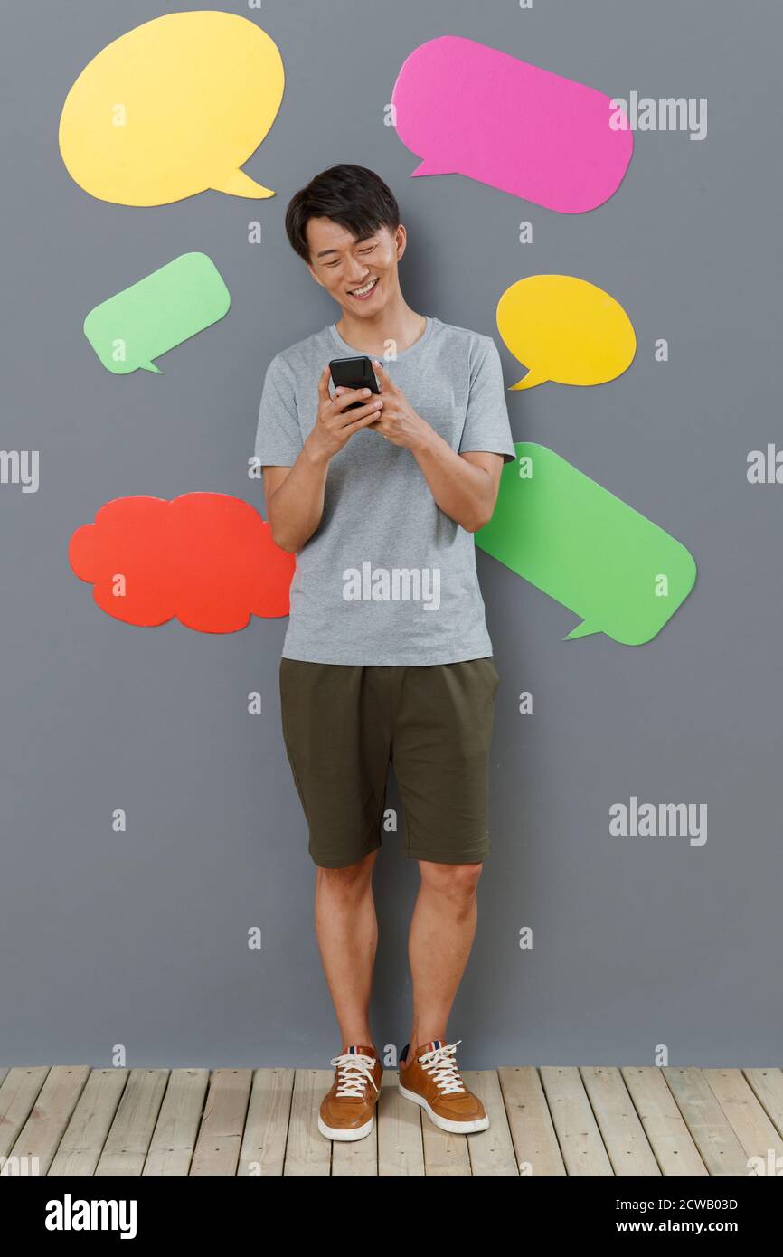 Take the young man mobile phone text messaging Stock Photo - Alamy