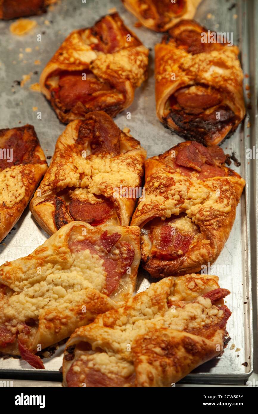 Unhealthy looking Pastries in a shop window in Salisbury Stock Photo ...