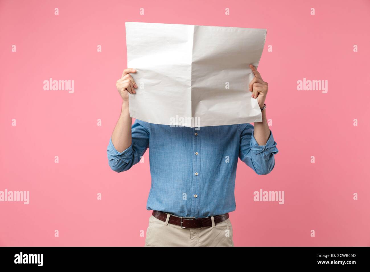 Hiding behind newspaper hi-res stock photography and images - Alamy
